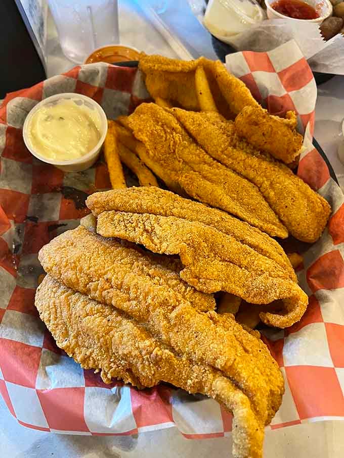 Golden fried catfish strips so perfectly crispy they could make a Southern grandmother weep tears of joy and approval.