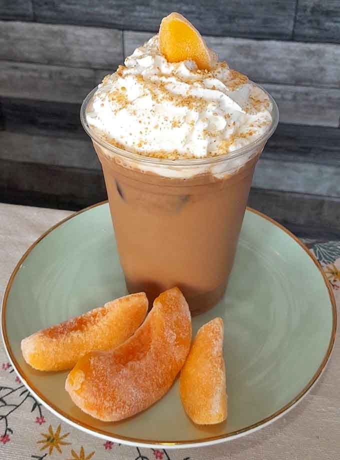 Peach cobbler iced coffee topped with whipped cream – basically summer in Alabama in a cup.