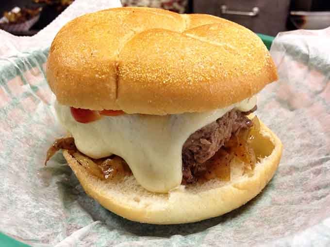 Caramelized onions and a blanket of creamy cheese transform this steamed burger into something that belongs in a comfort food hall of fame.