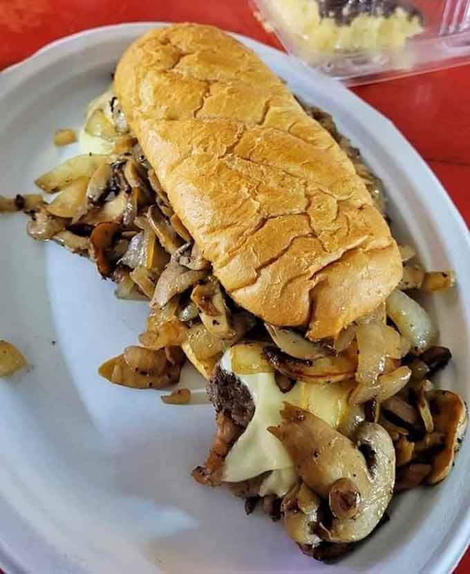 That ribeye sandwich overflows with meat and mushrooms, making portion control look like a silly urban legend.