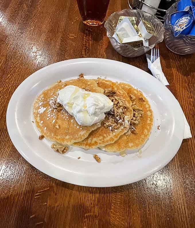 Pancakes topped with whipped cream and nuts: because sometimes breakfast needs to feel like a celebration.