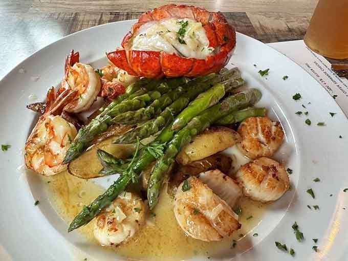 Scallops, shrimp, and lobster tail together on one plate is basically the seafood equivalent of a supergroup reunion.