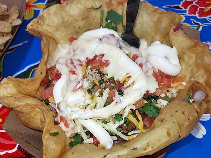 A taco salad served in a crispy tortilla bowl, because apparently someone decided regular bowls weren't fun enough.