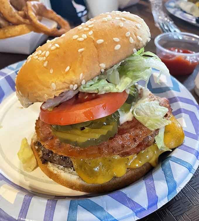 Bacon draped over a burger like a delicious blanket, because some things just belong together forever.