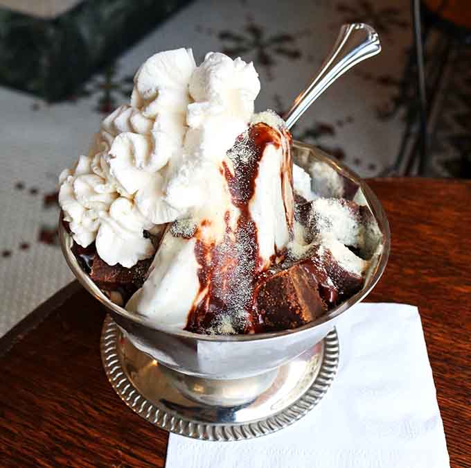 Chocolate and vanilla ice cream colliding in a silver dish like Mount Vesuvius erupting with deliciousness instead of lava.