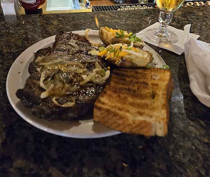 Caramelized onions cascading over a juicy ribeye create the kind of aroma that makes neighboring tables jealous and hungry.