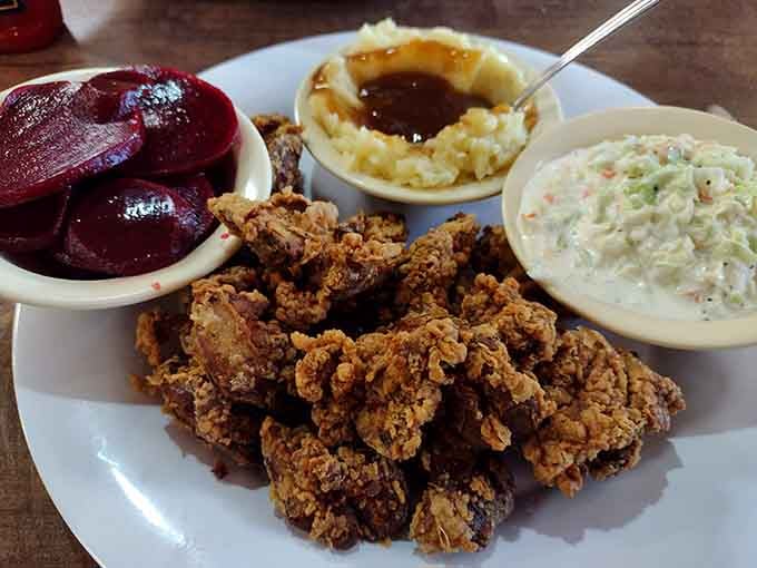 Fried chicken livers with mashed potatoes, coleslaw, and sliced beets, a plate that separates the adventurous eaters from the timid ones.