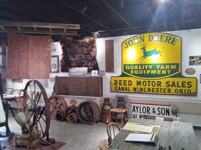 Agricultural heritage meets barbering history with vintage John Deere signs reminding visitors that Canal Winchester has always been farming country.
