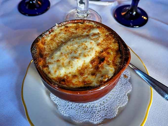 French onion soup bubbling under a golden cheese blanket, the kind of comfort that transcends centuries and generations.