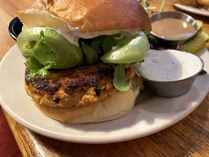 That salmon burger sits tall and proud, proving fish can hold its own against any beef patty.