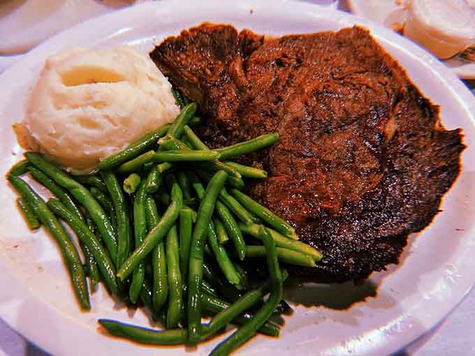 A prime rib platter that looks like it was designed by someone who truly understands carnivorous joy.