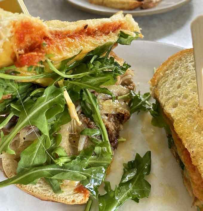 Duck confit grilled cheese with arugula, because sometimes sophistication needs to meet its melty, crispy destiny.