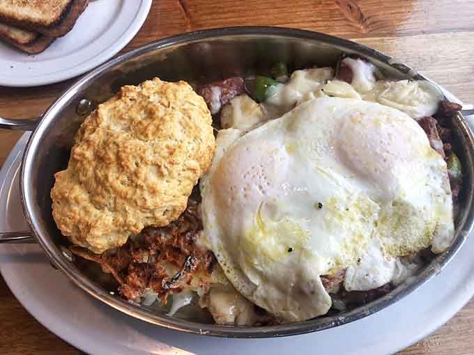 Corned beef hash gets the royal treatment here, topped with eggs and a biscuit that deserves its own zip code.