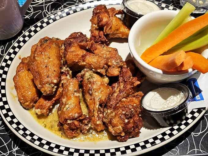 Golden wings piled high enough to make you question your dinner plans and your self-control simultaneously.