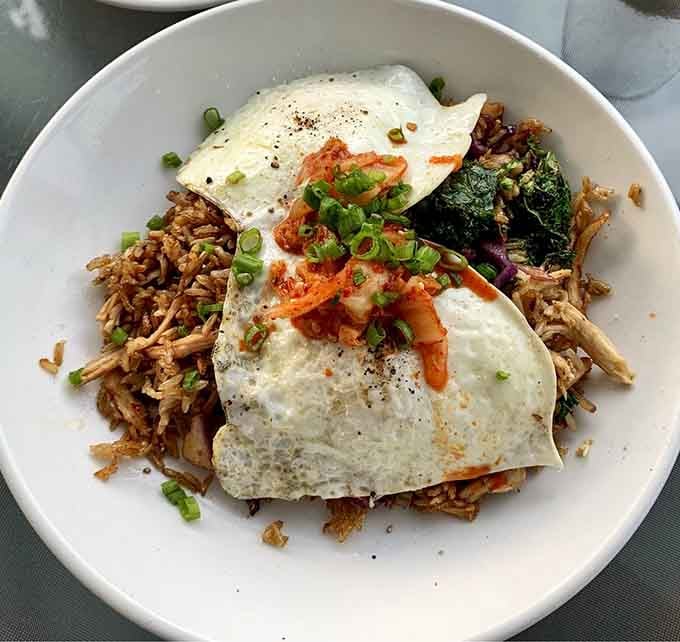 OG Fried Rice topped with sunny eggs and kimchi transforms breakfast into an adventure your fork won't forget.