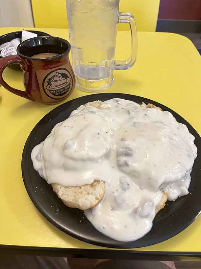 Biscuits drowning in creamy sausage gravy, the kind of comfort food that makes you understand why people drive hours for breakfast.