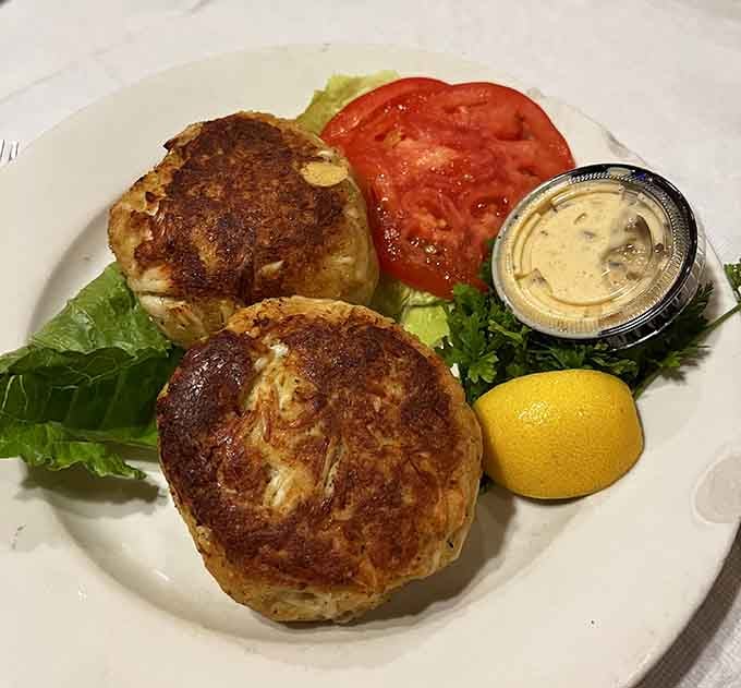 Golden-brown crab cakes served with a wedge of lemon show Maryland knows how to treat its seafood right.