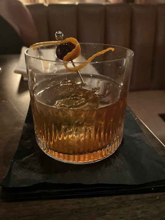 That orange twist and cherry garnish aren't just pretty, they're edible proof that someone really cares about your experience.