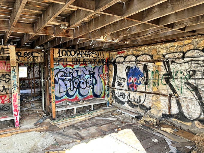 The graffiti-covered interior reveals layers of visitors who've left their colorful marks on history.