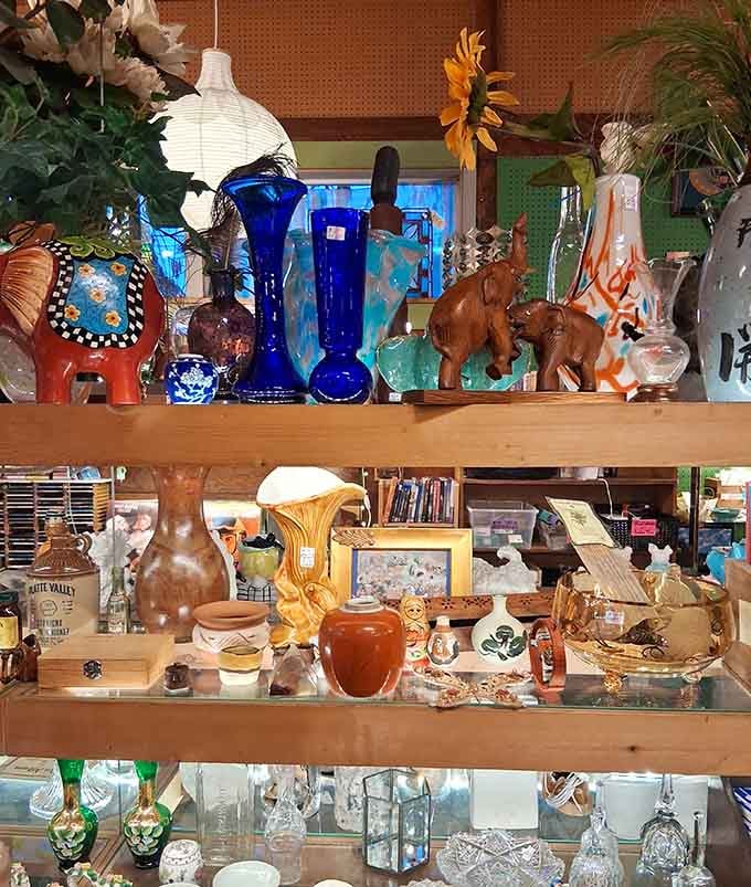 Blue glass bottles and ceramic creatures create a shelf display that's part museum, part treasure hunt.
