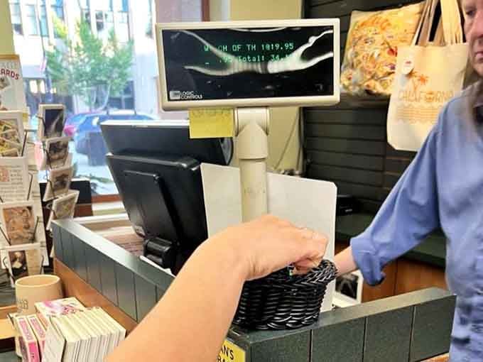 The checkout counter where dreams are purchased and reading lists grow exponentially with each friendly transaction.