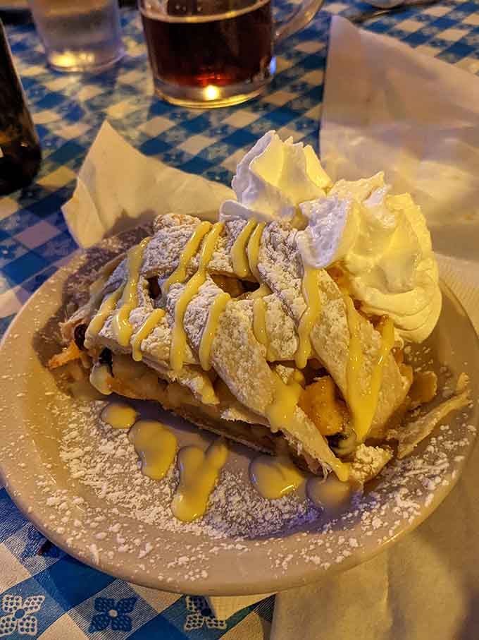 Apple strudel topped with whipped cream and powdered sugar makes you understand why dessert has its own stomach.