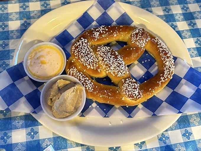 A proper Bavarian pretzel with cheese sauce and mustard &ndash; because some traditions are too delicious to mess with.