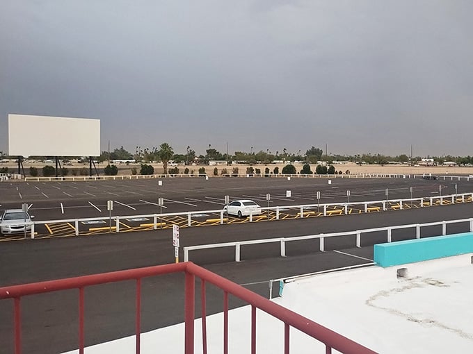 Rows of perfectly spaced parking spots await their nightly parade of vehicles and movie-loving families.