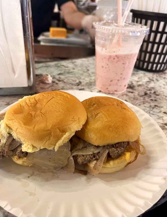 Two sliders loaded with caramelized onions and melted cheese, paired with a strawberry shake that's pure nostalgia.