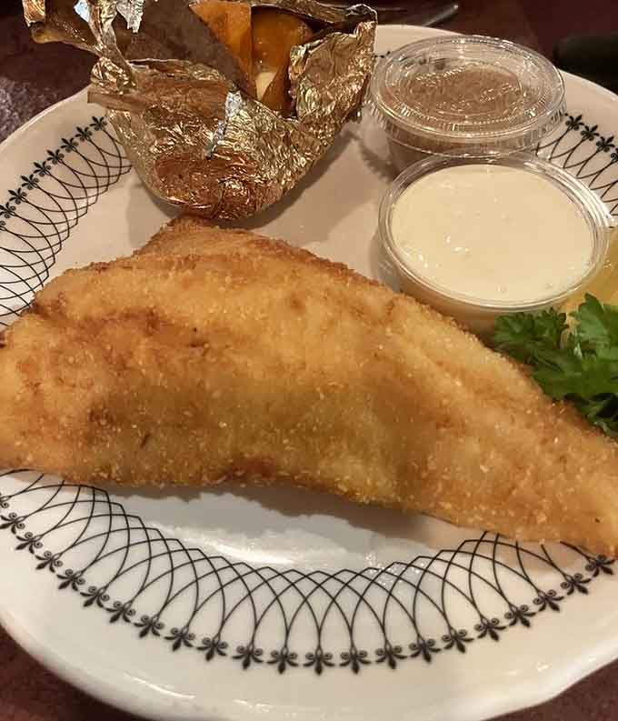 Walleye done right with a golden crust and foil-wrapped potato, because Minnesota knows its fish game cold.