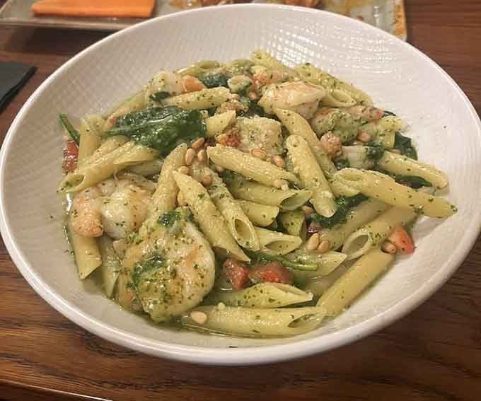 Shrimp and penne in a vibrant green sauce bring Italian-inspired flavors to life with pine nuts and fresh herbs.