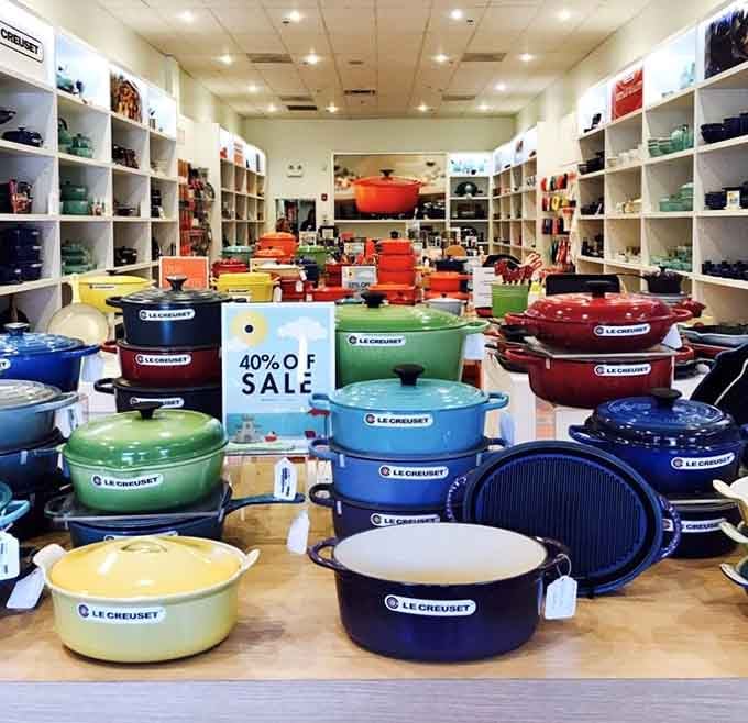 Le Creuset's colorful Dutch ovens gleaming like culinary jewels, transforming cooking dreams into affordable reality for home chefs everywhere.