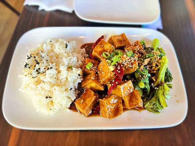 Szechuan tofu over rice with bok choy proves vegetarian dishes can steal the entire show.