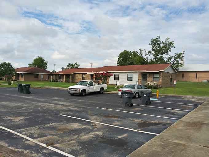 Modest brick apartments stretch across green lawns where community means looking out for each other, always and forever.