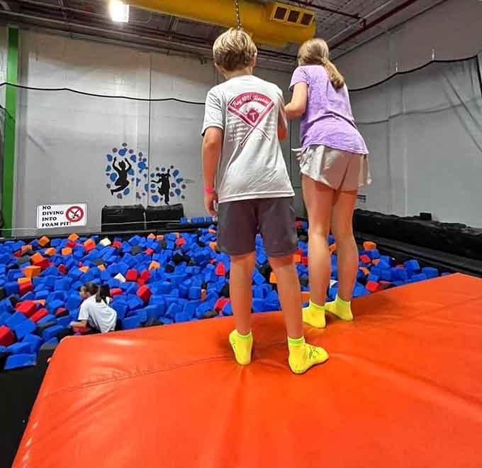 The foam pit awaits below like a colorful safety net for all your aerial ambitions and questionable decisions.