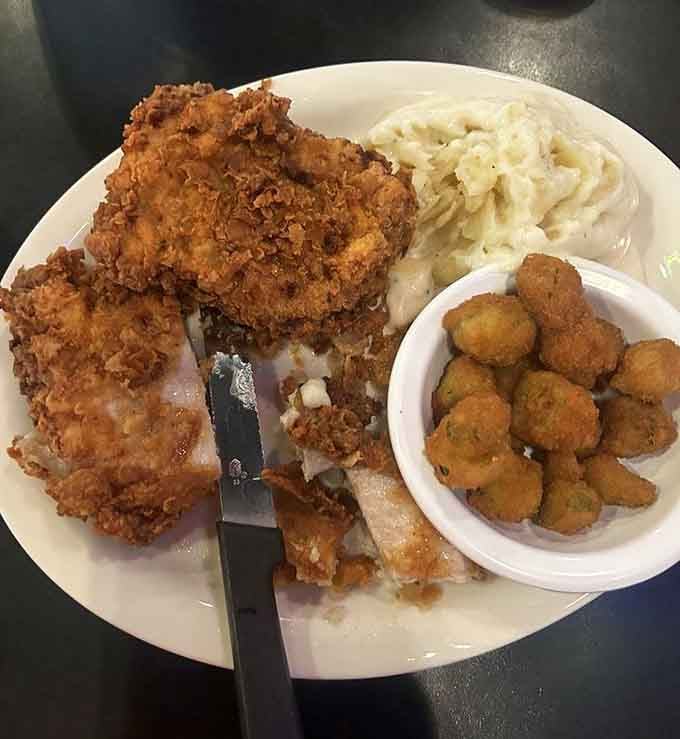 Fried pork chops, mashed potatoes, and okra: comfort food that would make your grandmother proud.