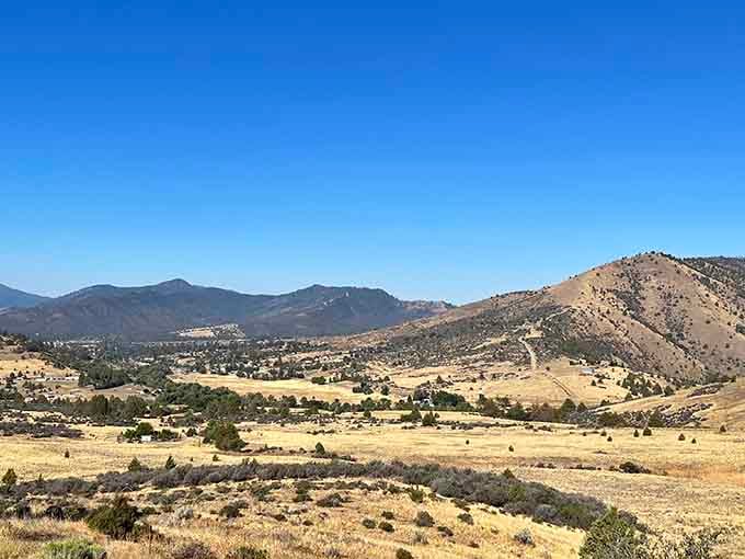 Golden hills roll toward distant peaks, offering the kind of wide-open scenery that makes your soul exhale deeply.