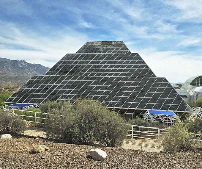 That massive glass pyramid rising from the desert looks like a spaceship designed by botanists with unlimited imagination.