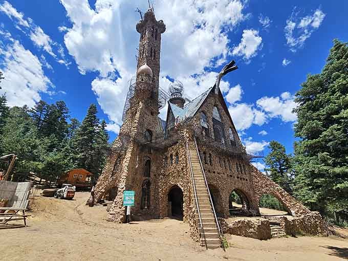 One man's vision in stone reaches skyward, defying gravity and building codes with equal determination and impressive stubbornness.