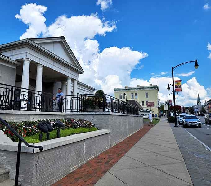 Greek Revival columns and manicured flower beds show a town that takes pride in every architectural detail and bloom.
