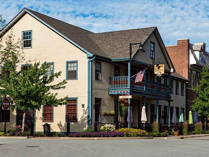 That yellow colonial building with its welcoming porch practically begs you to sit down and stay awhile, friend.