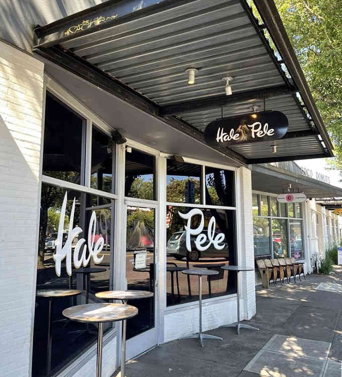 Clean white exterior and bold script lettering signal your tropical escape has arrived on this bustling Portland street corner.