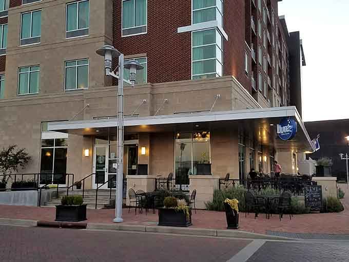 Modern brick plaza meets waterfront dining vibes, where evening meals feel special without requiring a yacht club membership.