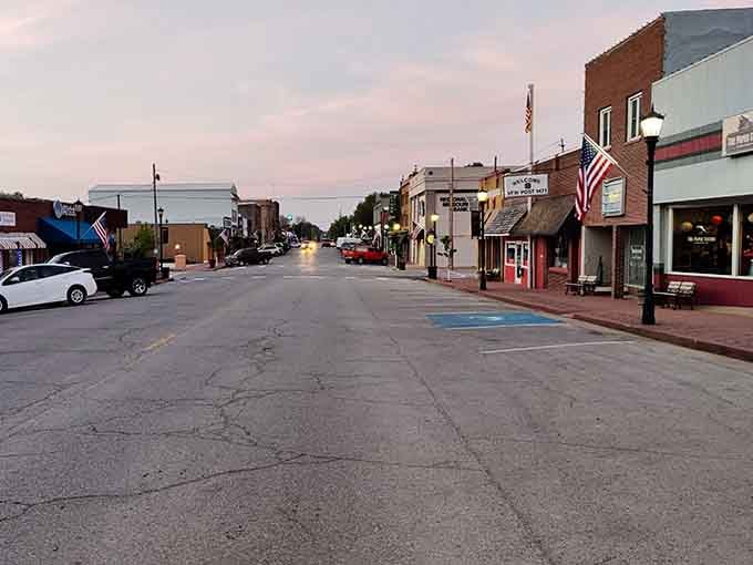 Dusk settles over Main Street as streetlights flicker on, creating the kind of scene Norman Rockwell would've loved painting.
