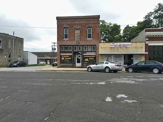 Classic brick storefronts line Marshfield's main street, where local businesses serve the community and preserve the town's authentic small-town character.