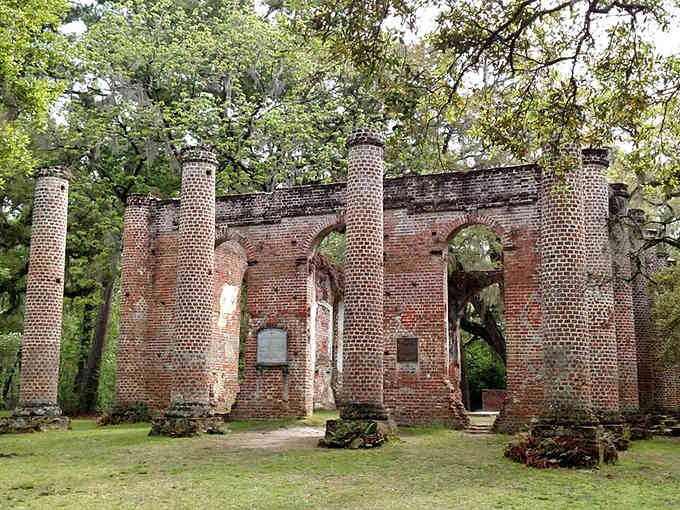Brick columns reach skyward without a roof, Spanish moss draping the ruins like nature's way of honoring what once was.