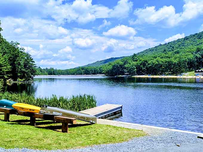 Bright yellow kayaks rest beside a wooden dock, ready to launch you into a peaceful mountain lake adventure.