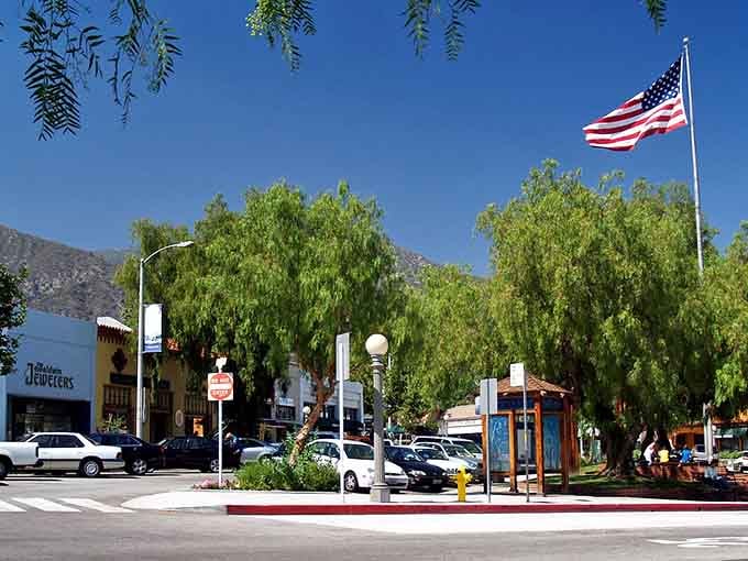 That American flag waves proudly over a town square where neighbors still meet for coffee and conversation every morning.