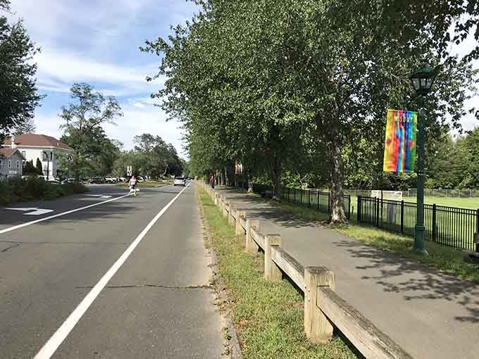 Enjoy a peaceful, sun-drenched stroll along this lovely, tree-lined path in Simsbury, perfect for a relaxing day outdoors anytime.