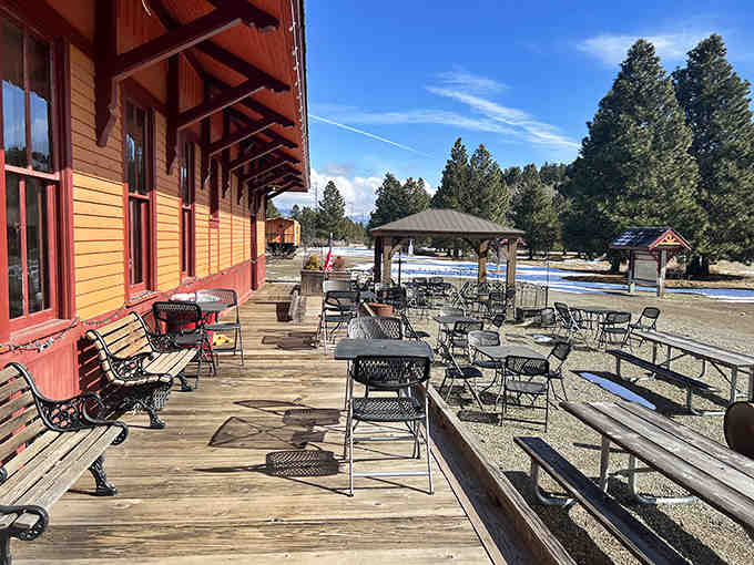 That expansive wooden deck overlooks open spaces where blue skies meet BBQ dreams on sunny afternoons worth remembering forever.